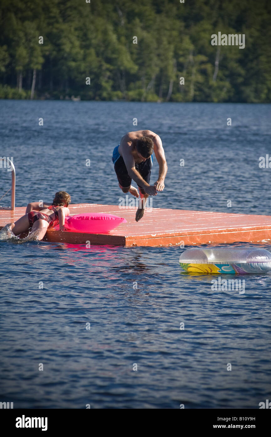 diving from floating swimming platform summer camp Stock Photo - Alamy