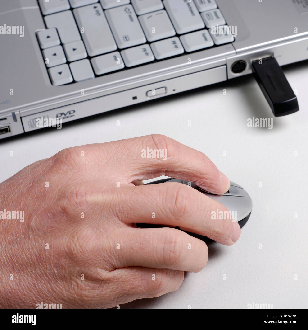 Laptop user with a mini usb wireless mouse Stock Photo - Alamy