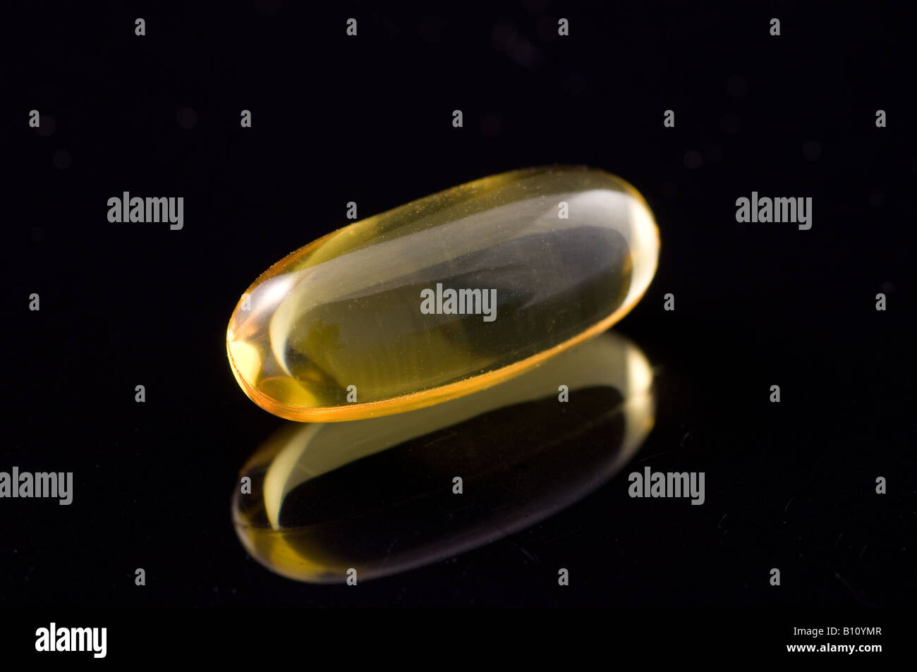 Closeup of a fish oil tablet on a shiny black background Stock Photo ...