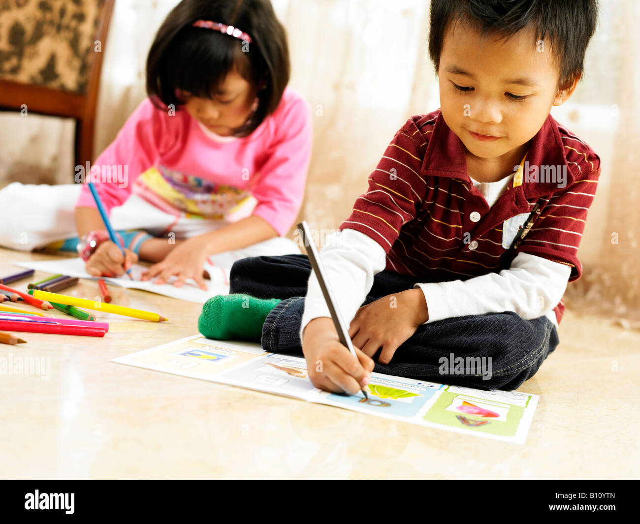 Children colouring with colour pencils Stock Photo - Alamy
