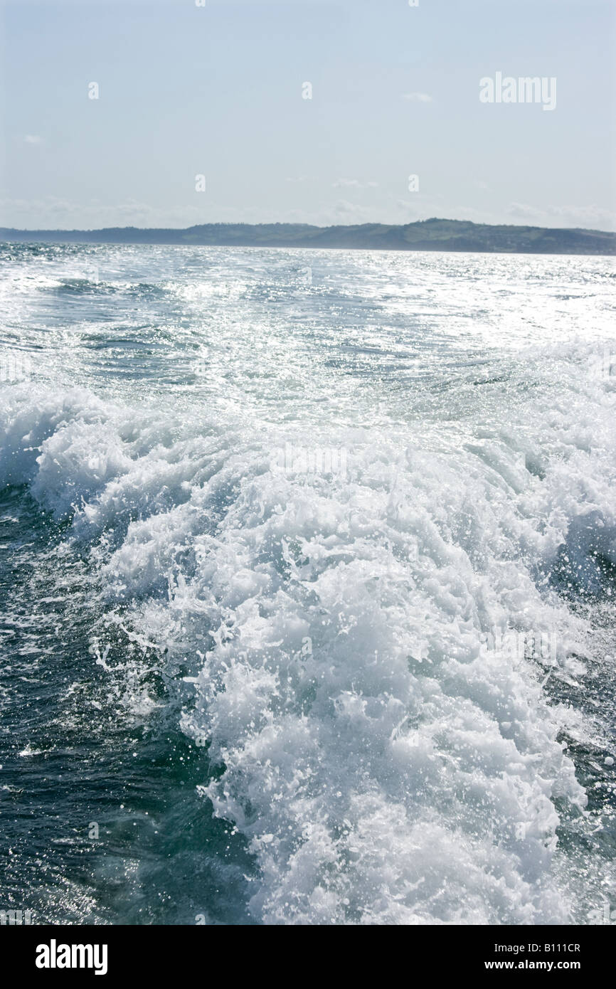 Boat's wake taken with a fast shutter speed showing suspended droplets ...