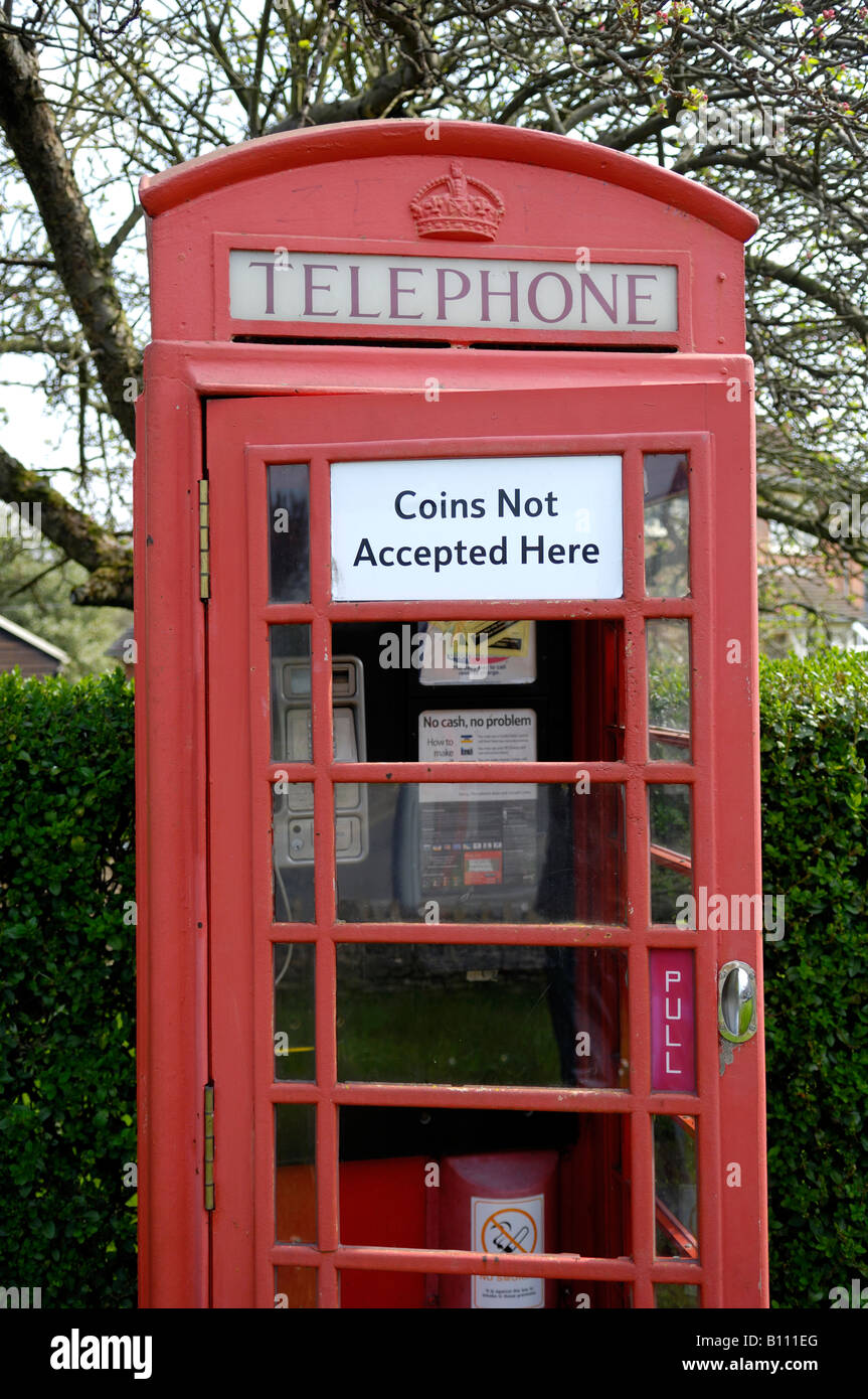UK telephone box with no coins sign Stock Photo - Alamy