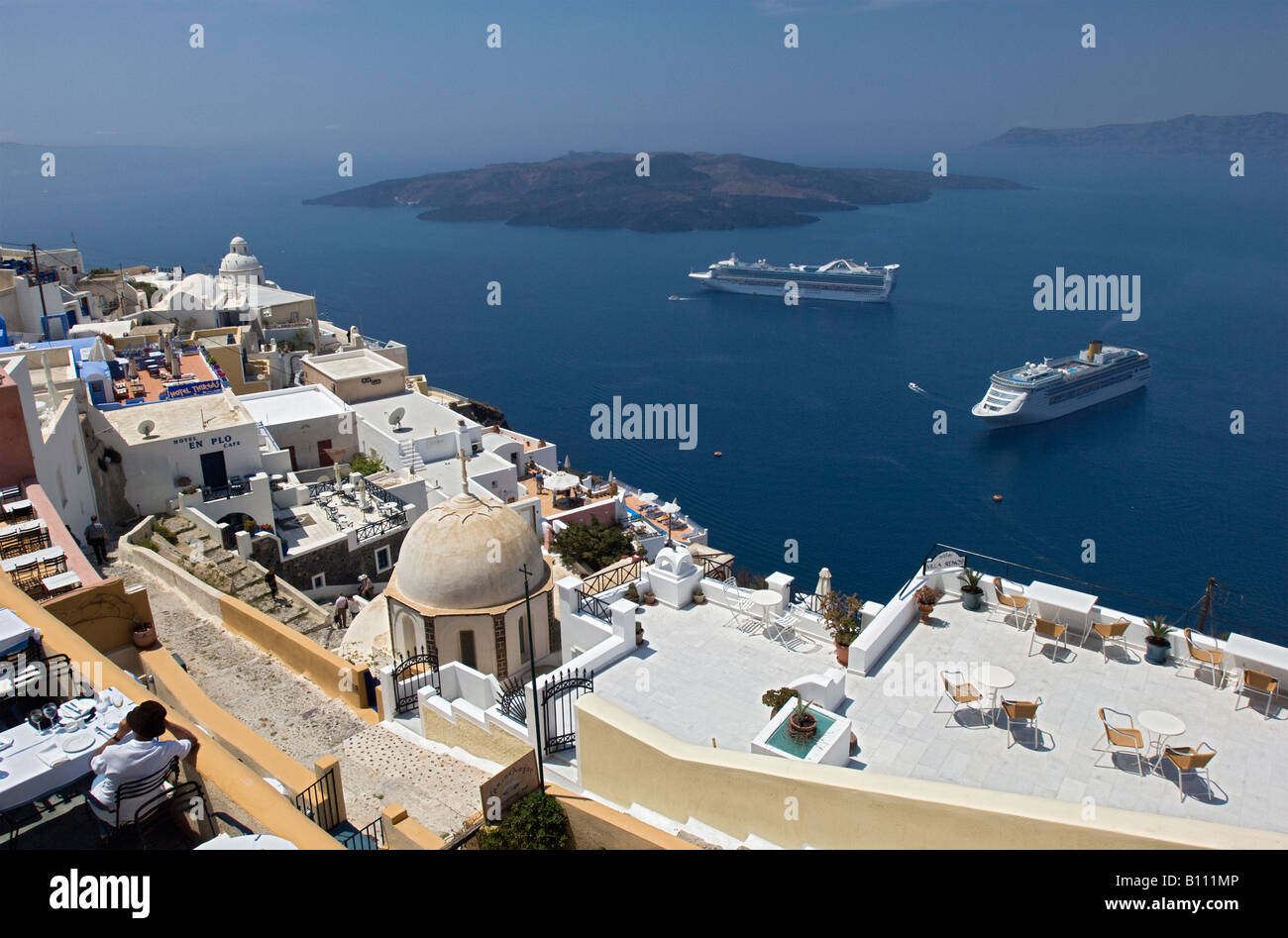 View over the White Rooftops of Santorini with Cruise Ships Anchored in ...