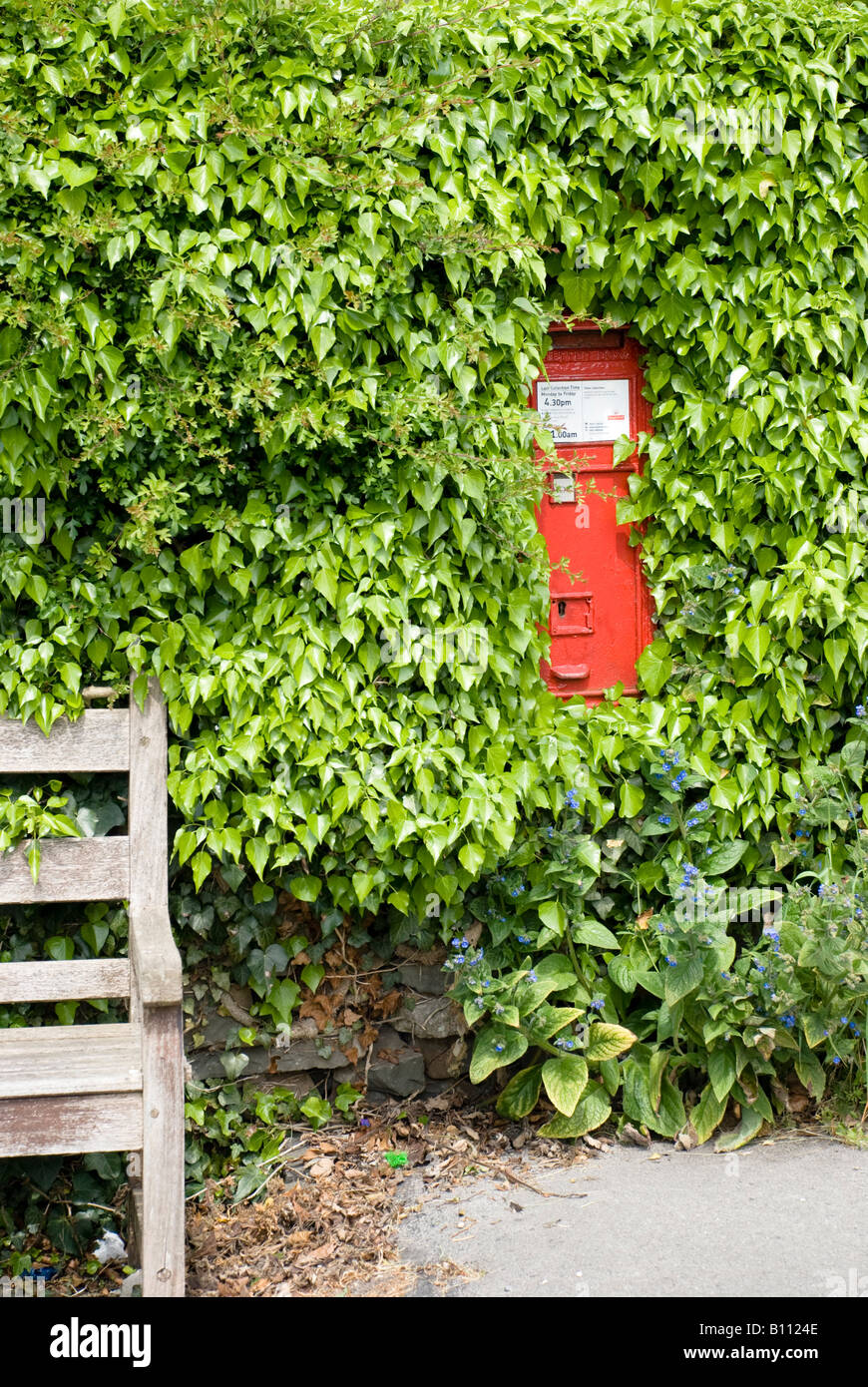 gpo red post box and village seat Stock Photo - Alamy