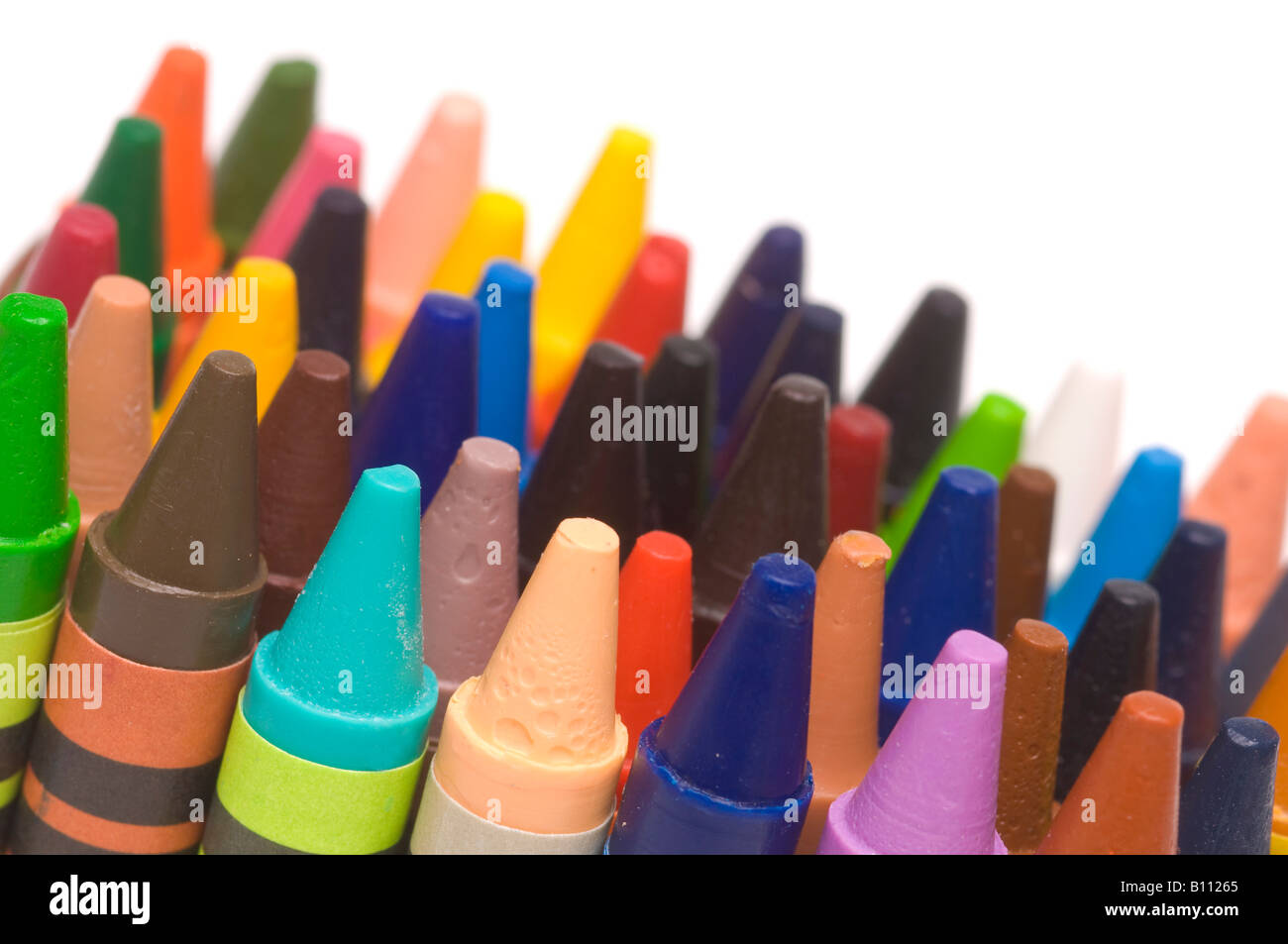 Multicoloured selection of wax crayon tips angled on a white background ...