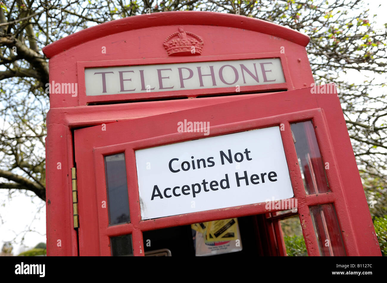 UK telephone box with no coins sign Stock Photo - Alamy