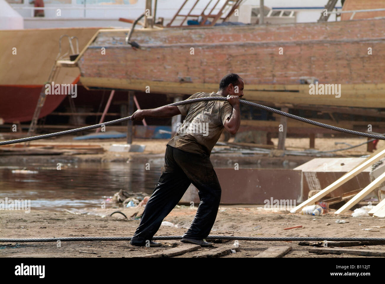 Dock workers pulling a rope Stock Photo - Alamy