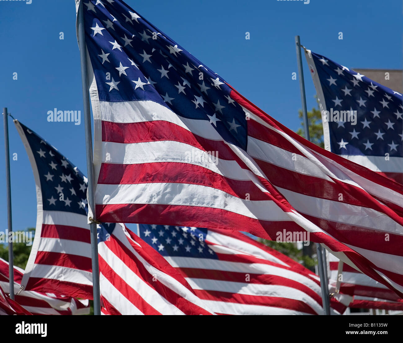 Photograph of several flags against a blue sky Stock Photo - Alamy
