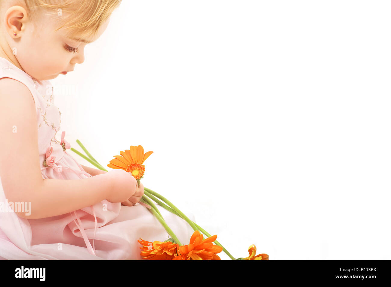 Girl playing with flowers Stock Photo - Alamy