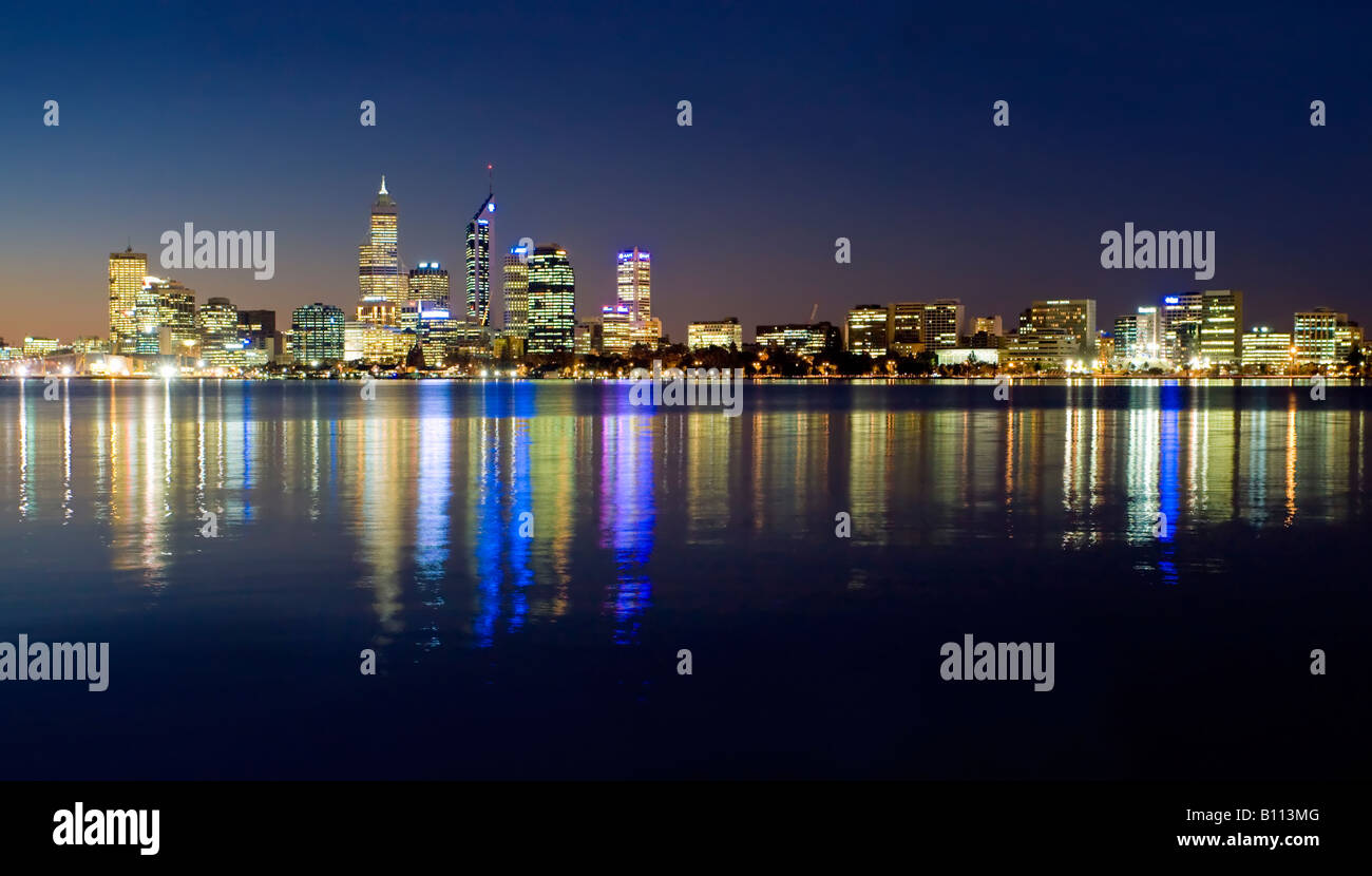The city at night with the skyscraper's lights reflecting in the Swan ...