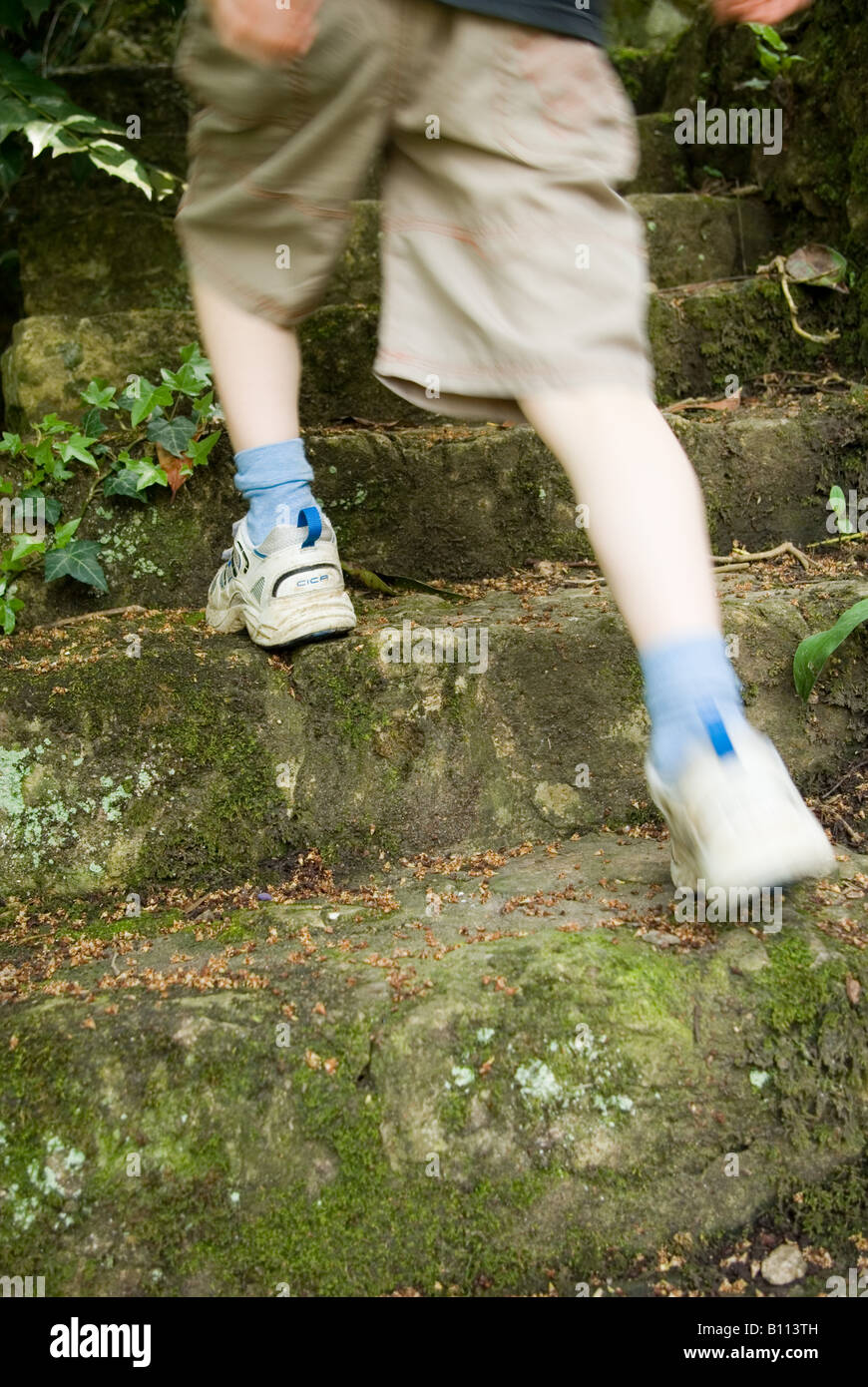 Boy running up stone steps Stock Photo - Alamy