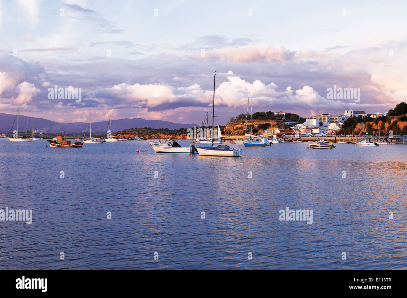 Alvor river boat harbour bay at sunset Algarve South of Portugal ...