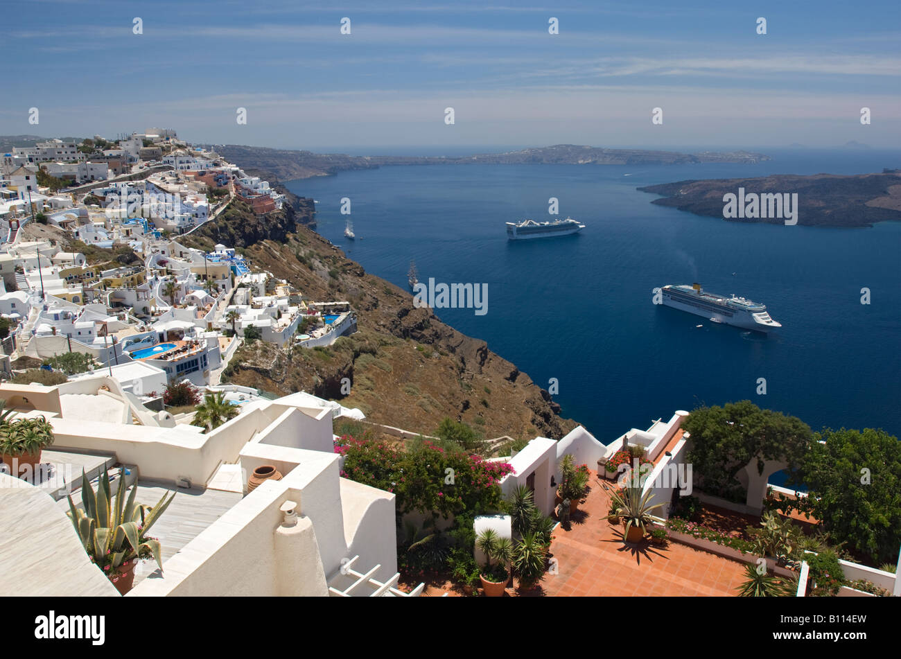 View over the White Rooftops of Santorini with Cruise Ships Anchored in ...