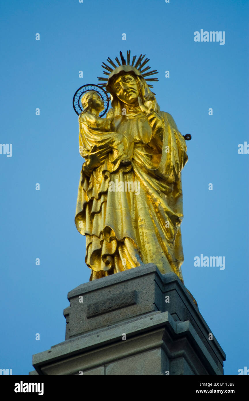 Gold plated statue of Jesus Christ and the Virgin Mary on a Catholic ...