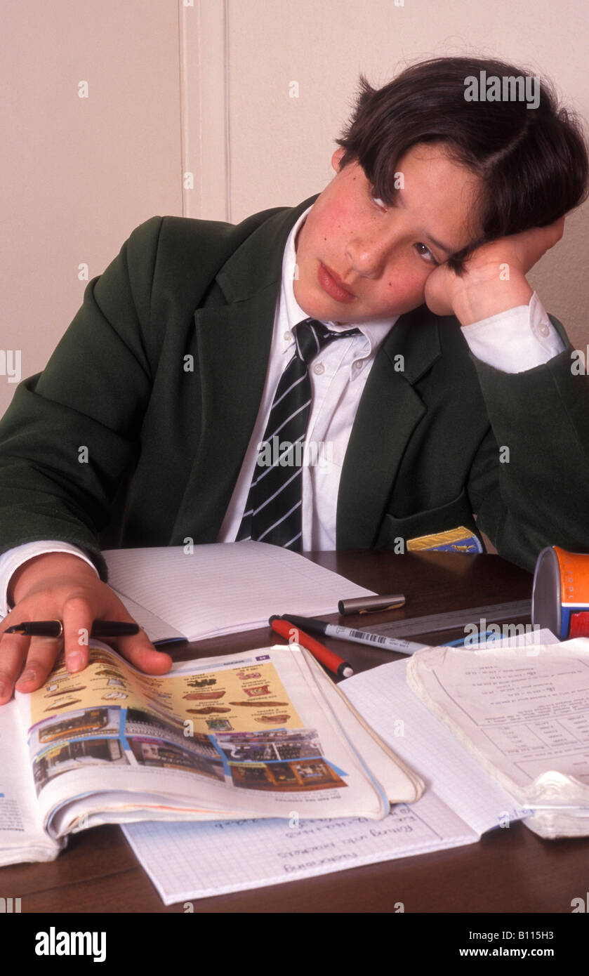 stressed boy in smart school uniform doing homework Stock Photo - Alamy