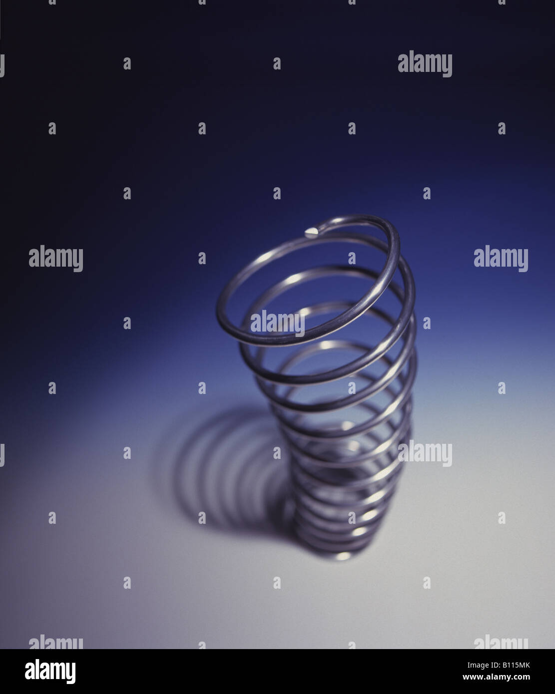 view from above of expanded metal spring on blue limbo background Stock ...