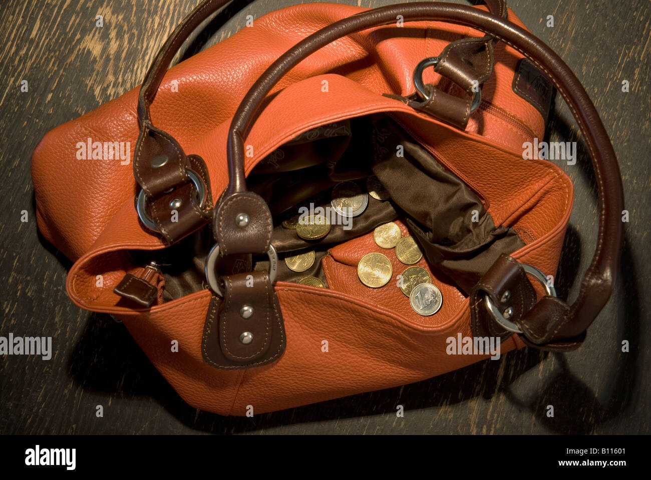 view into empty shoulder bag with nothing but loose coins Stock Photo ...