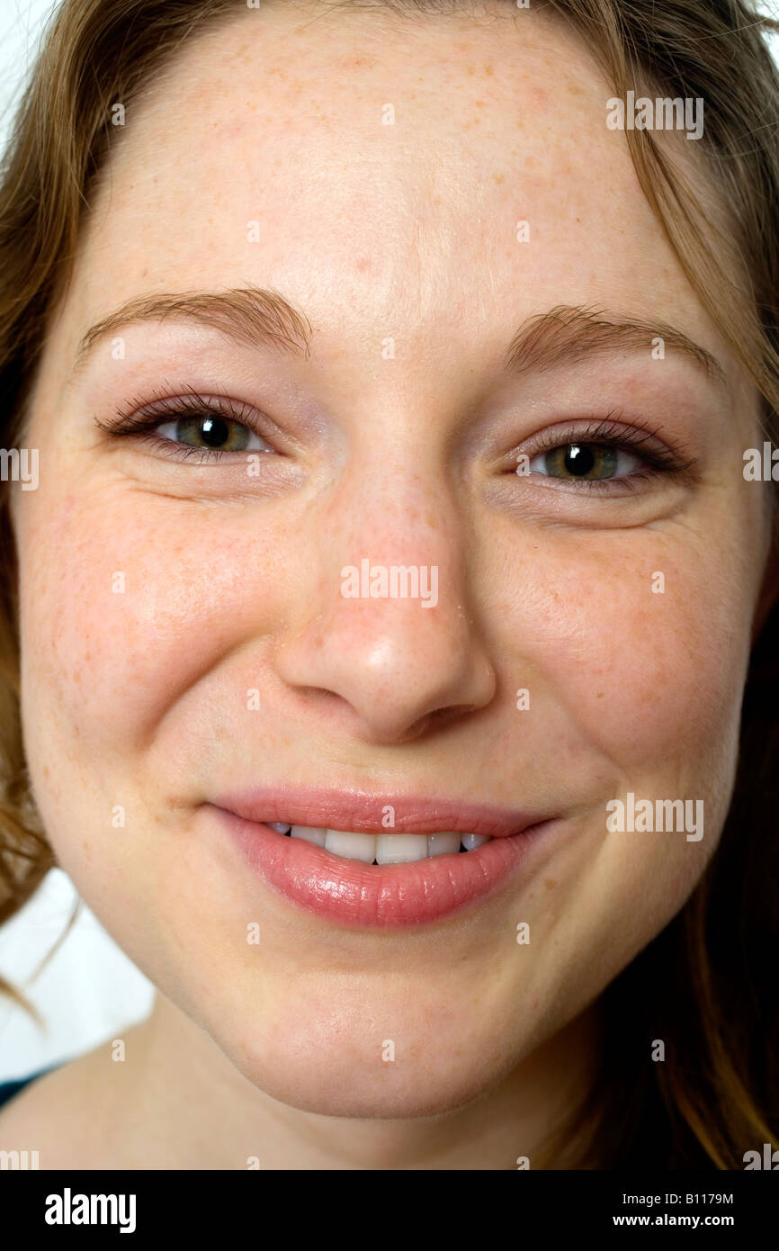 Young woman smiles brightly in Hollywood studio portrait head shot ...