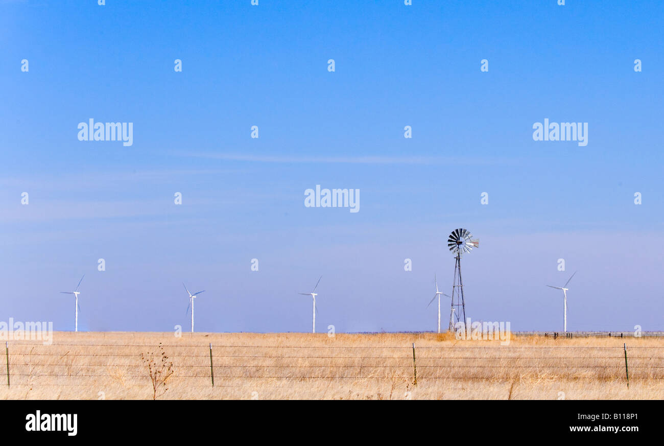 Old fashioned wind mills and new modern wind turbines are together in ...