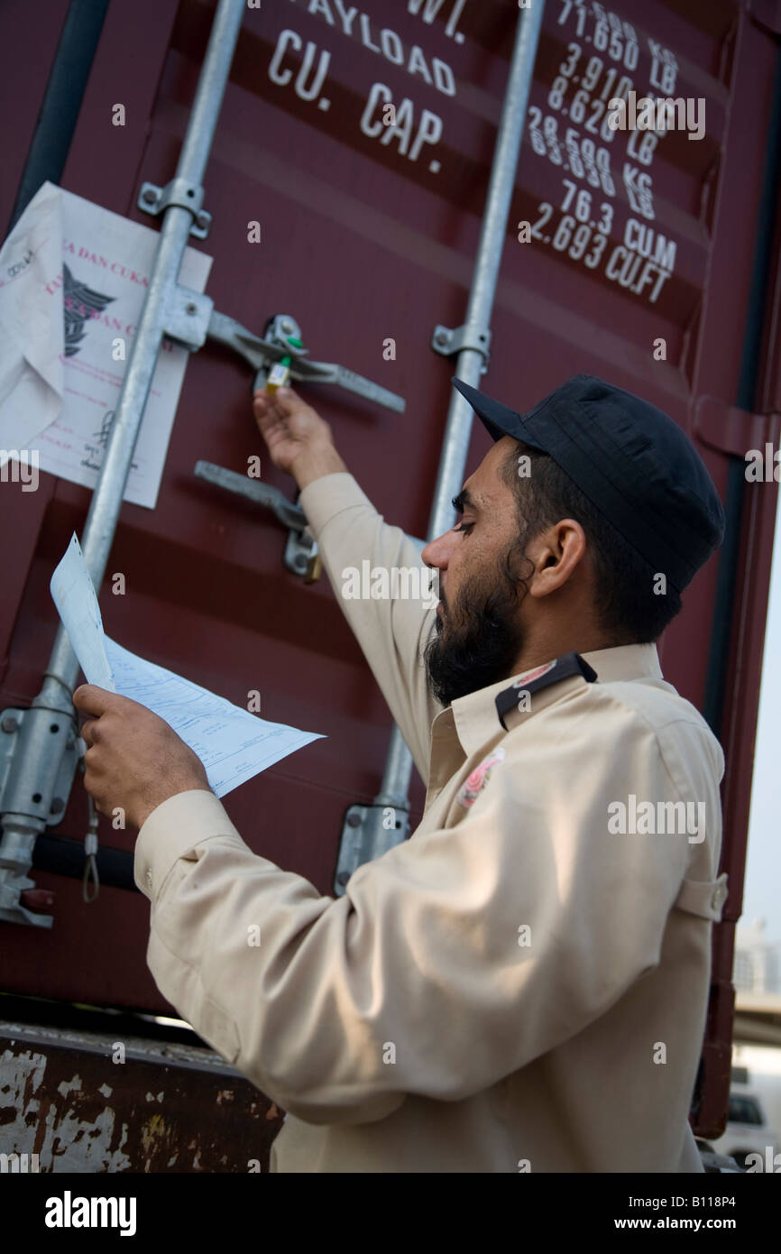 Security officer checking paperwork on container at port Khalid United ...