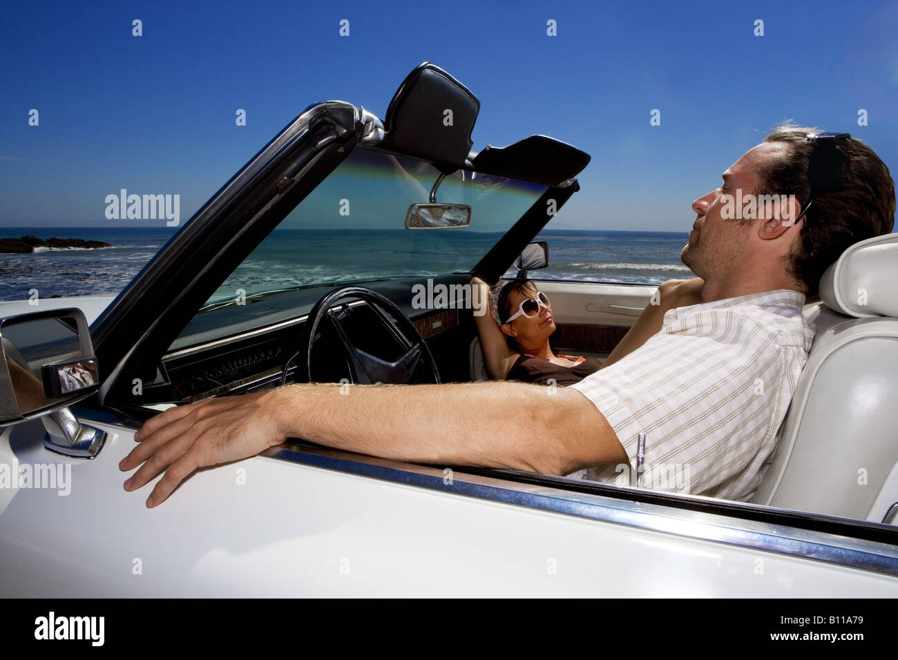 Couple relaxing in car Stock Photo - Alamy