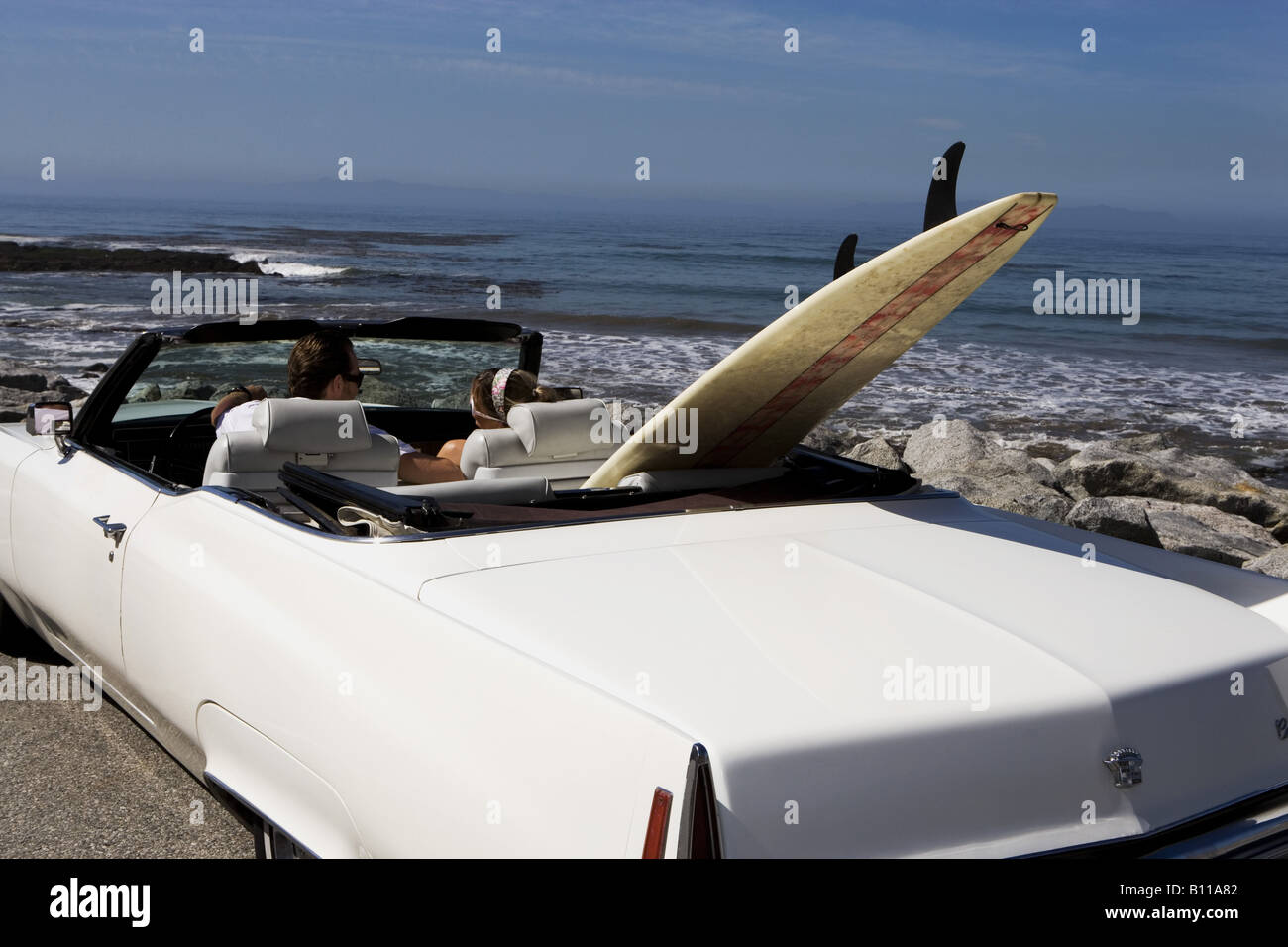 Couple relaxing in car at ocean Stock Photo - Alamy