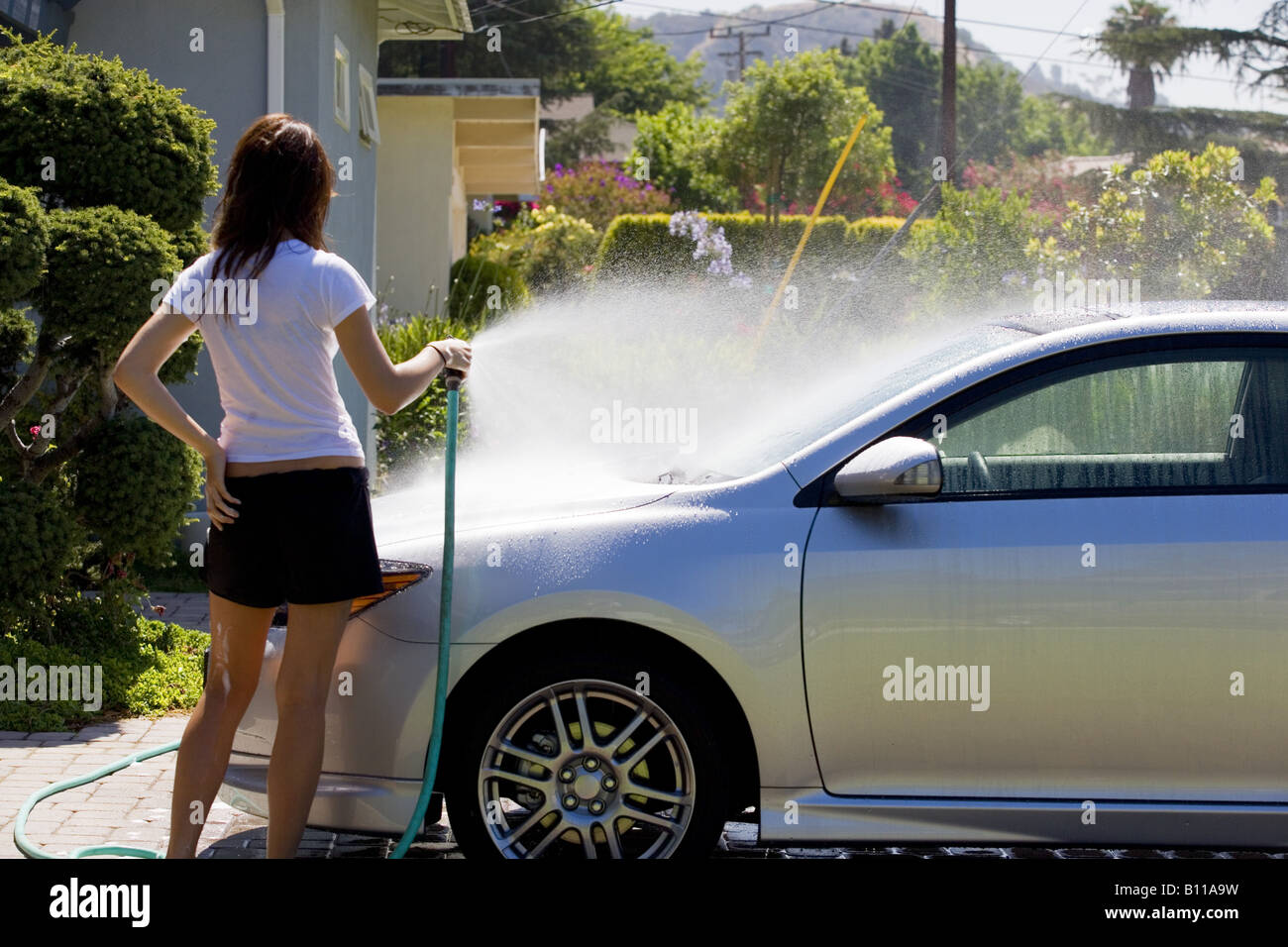 Teenage girl washing car Stock Photo - Alamy