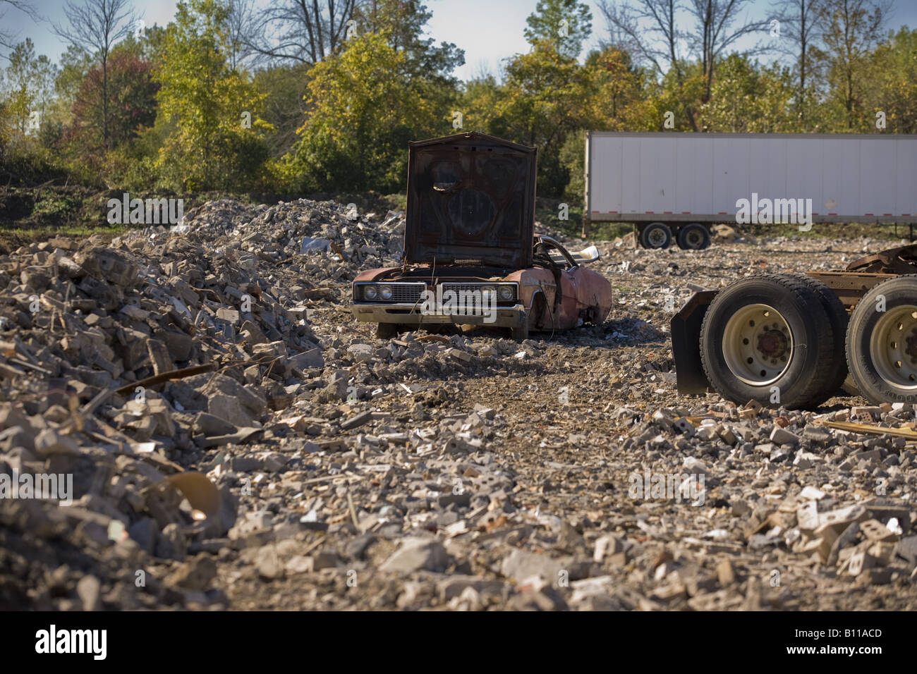 Wrecked car in wrecking yard with trailer Stock Photo - Alamy
