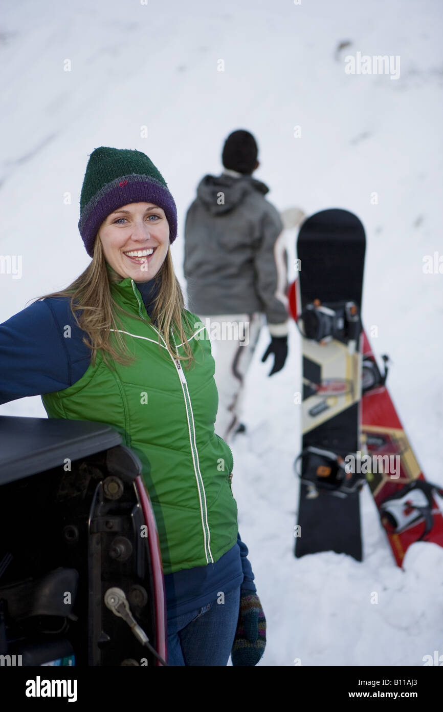 Young couple getting ready for snowboarding Stock Photo - Alamy