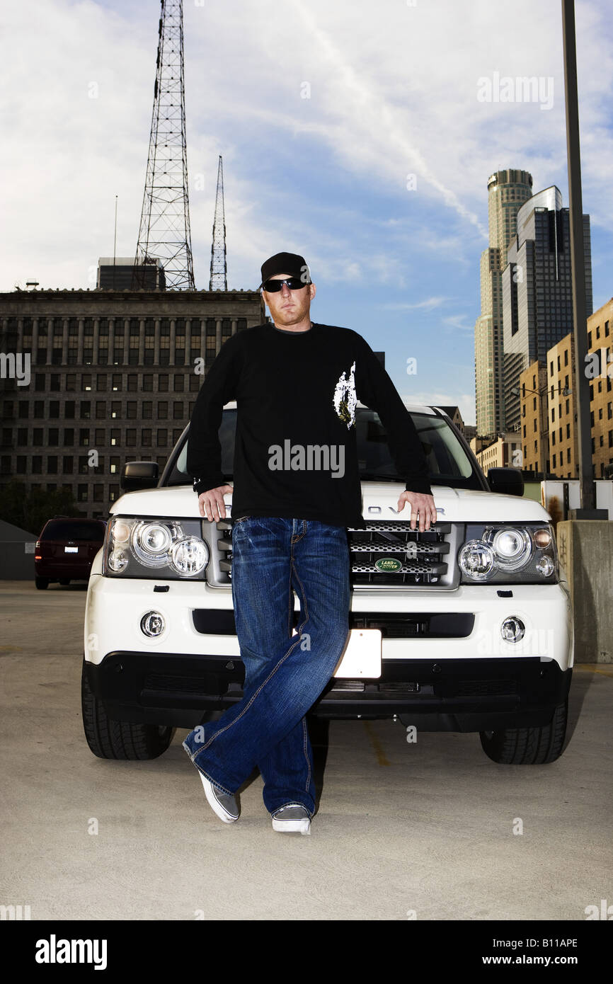 Young man leaning against front of 2007 Range Rover Sport Stock Photo ...