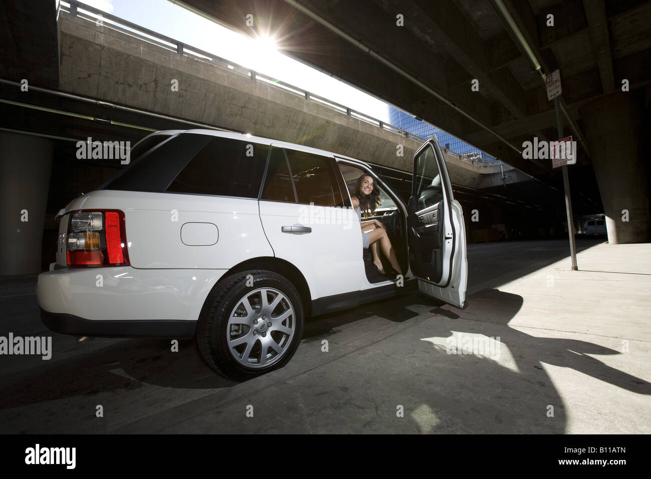 Young woman seated in white Range Rover Sport Stock Photo - Alamy