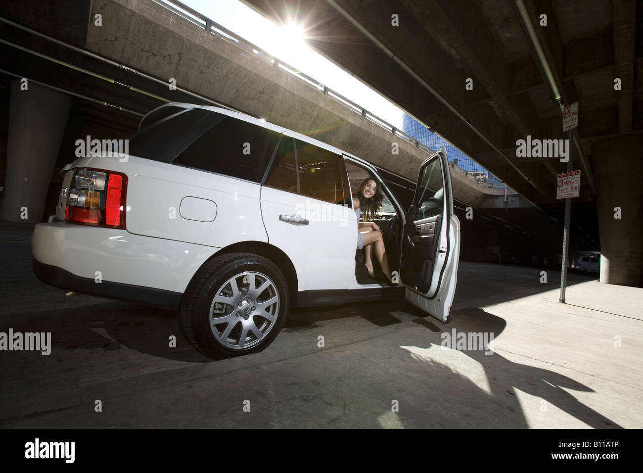 Young woman seated in white Range Rover Sport Stock Photo - Alamy