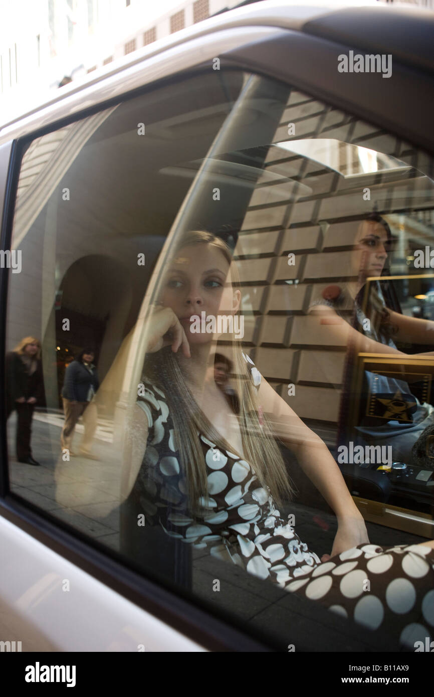 Two young women driving downtown in white SUV Stock Photo - Alamy