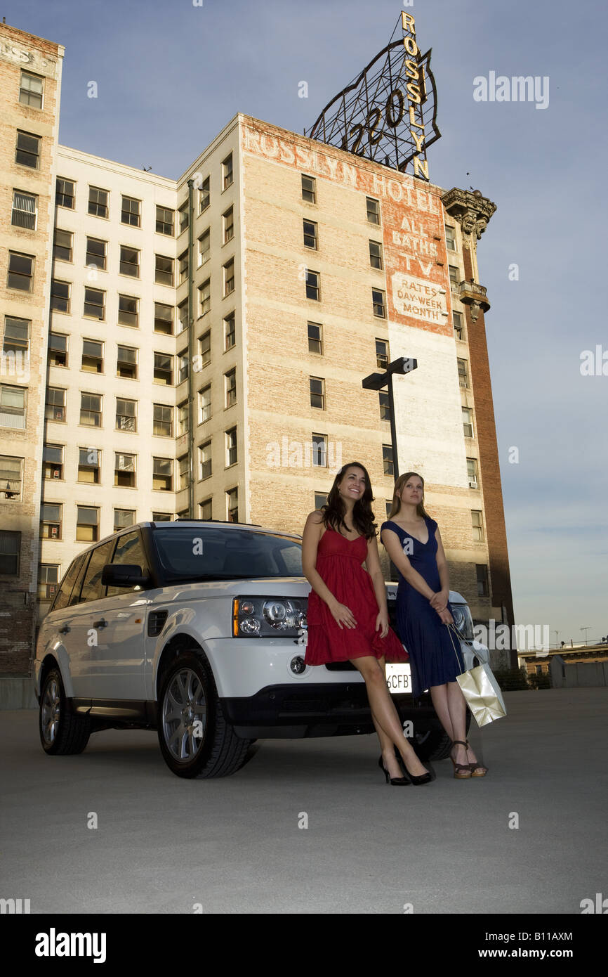 Young woman walking by white Range Rover Sport Stock Photo - Alamy