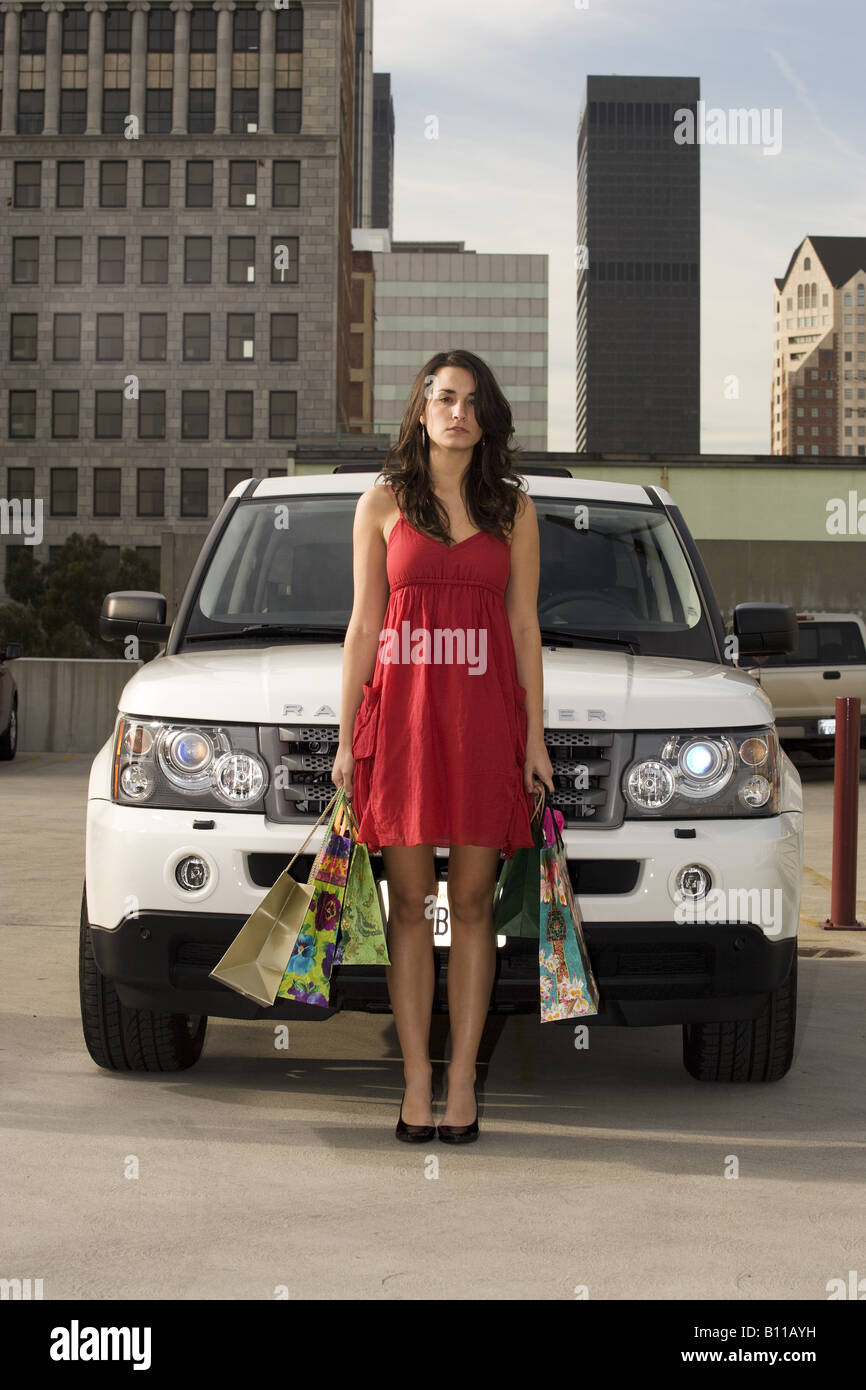 Young woman standing in front of white Range Rover Sport Stock Photo ...