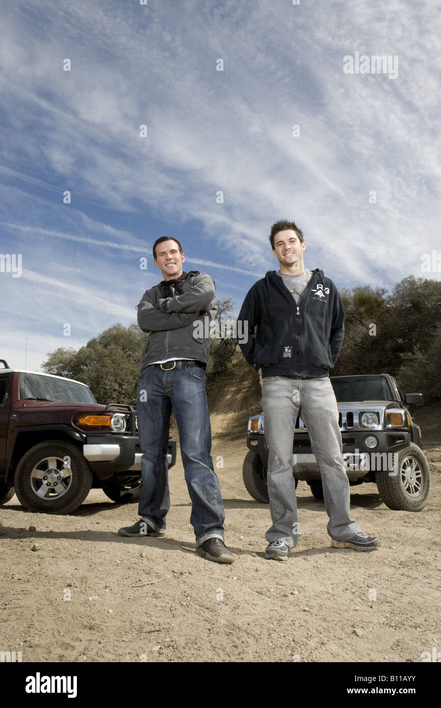 Two men in front of their off-road vehicles in desert Stock Photo - Alamy