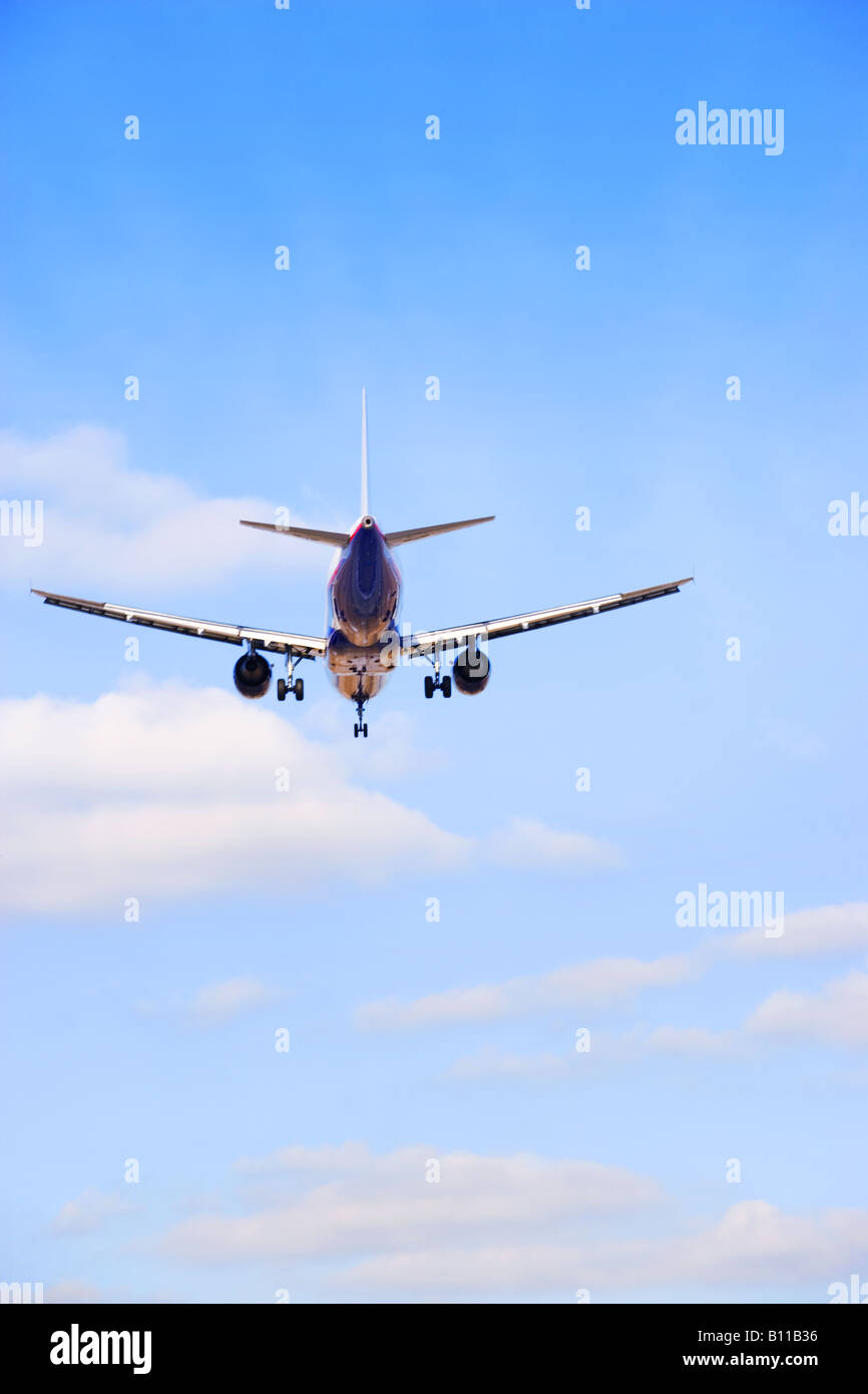 Blue airplane flying overhead Stock Photo - Alamy