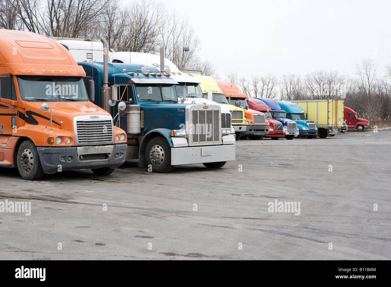 Row of trucks parked at truckstop Stock Photo - Alamy