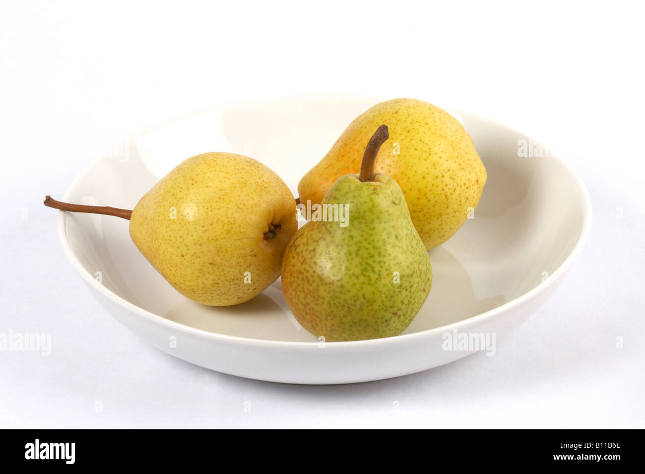 Three Pears in a white bowl Stock Photo - Alamy