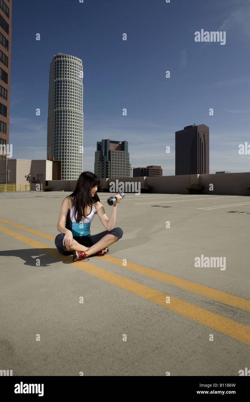 Woman seated on rooftop hi-res stock photography and images - Alamy