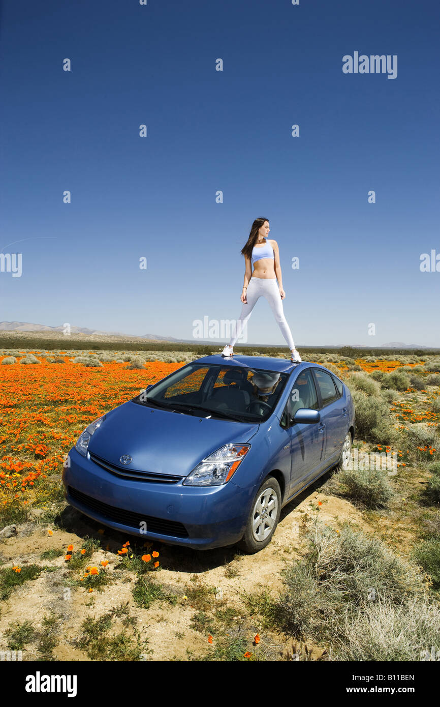 Young woman standing on top of blue Toyota Prius Stock Photo - Alamy