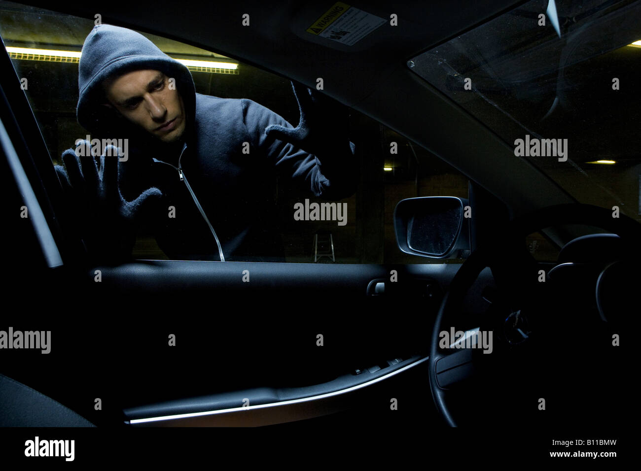 Thief looks in car window Stock Photo - Alamy