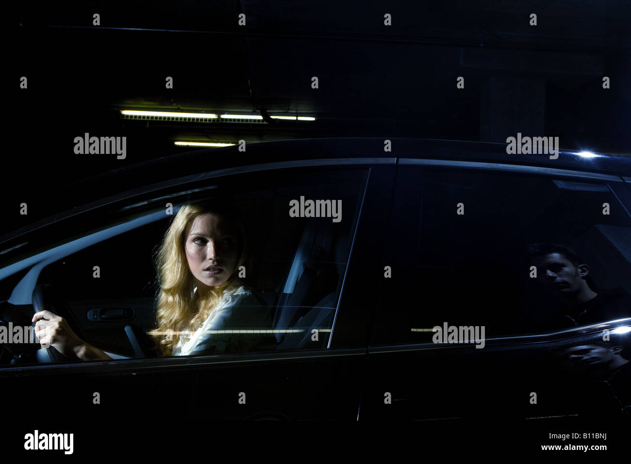Woman sees stalker through car window Stock Photo - Alamy