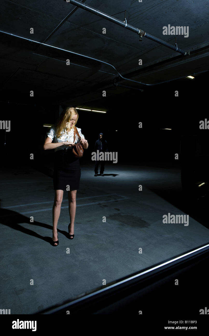 Woman checks her purse for keys as prowler approaches Stock Photo - Alamy