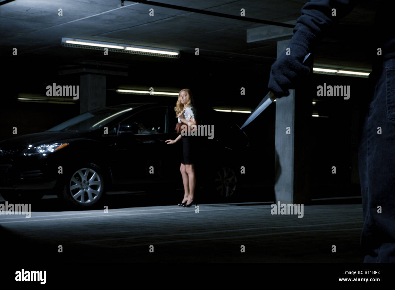 Woman sees prowler with knife as she unlocks her parked car Stock Photo ...