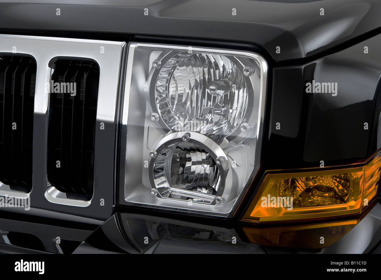 2008 Jeep Commander Sport in Black - Headlight Stock Photo - Alamy