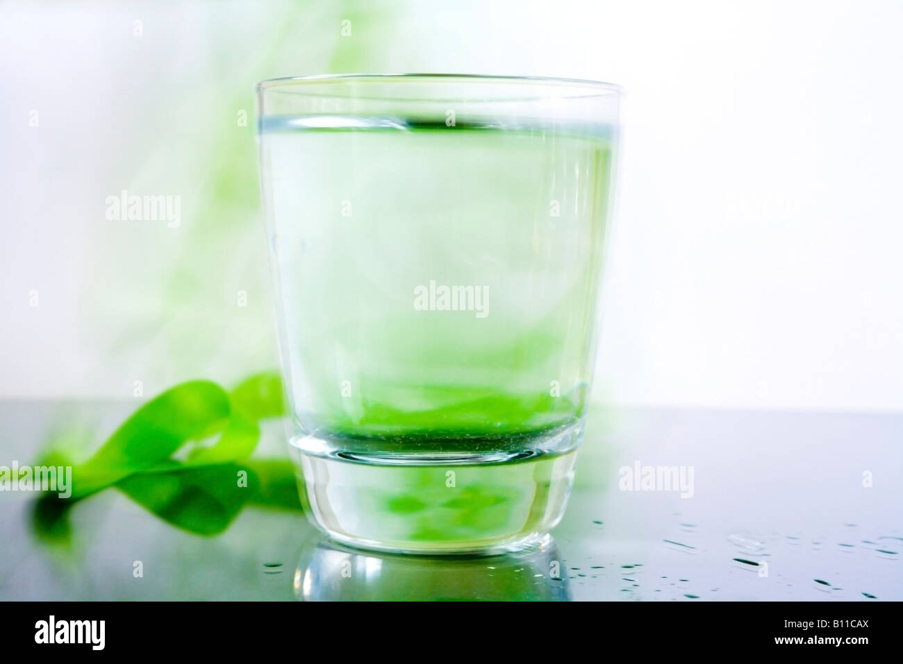 Glass of water and some abstract color Stock Photo - Alamy