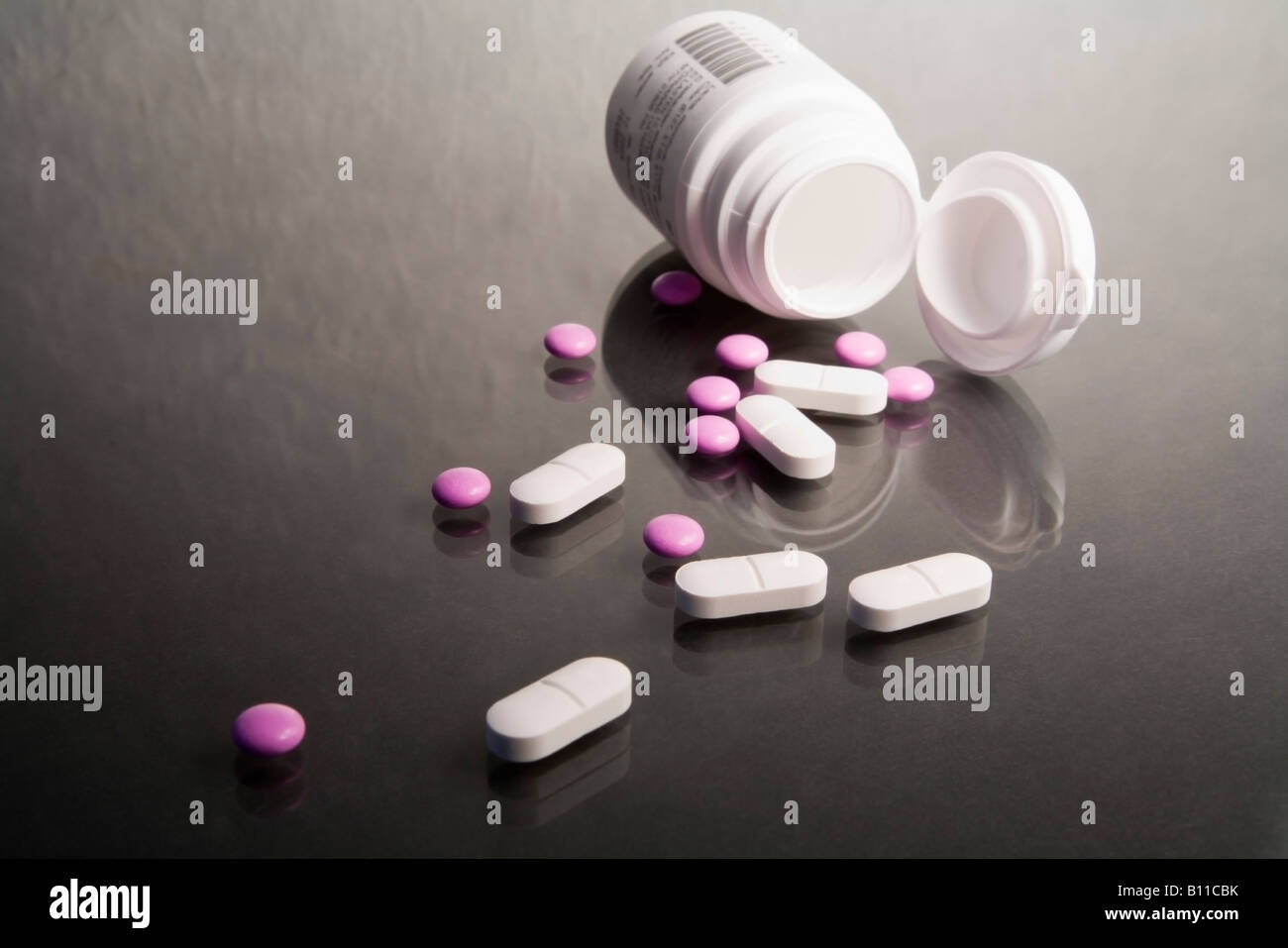 Medical tablets on a reflective glass surface Stock Photo - Alamy