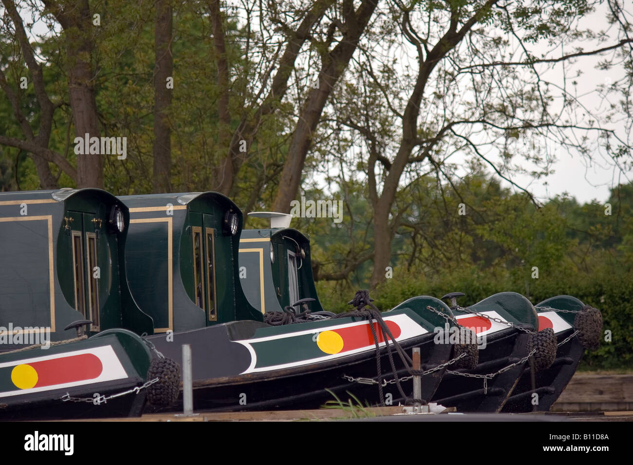 Line of moored barges at the side of a canal Stock Photo - Alamy