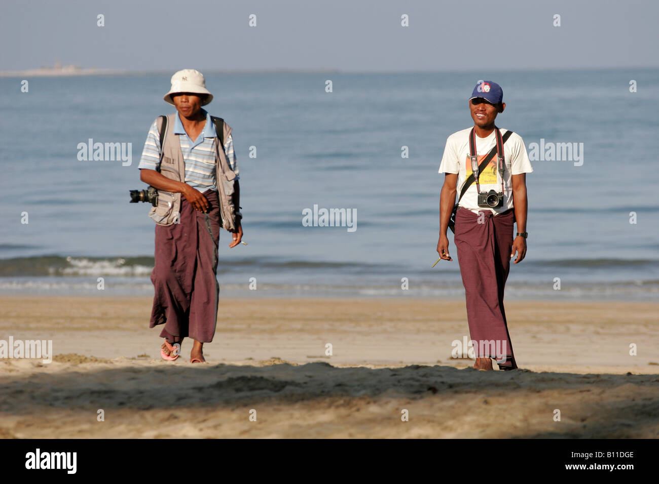 Two Burmese beach photographers walking on the beach, Burma (Myanmar ...